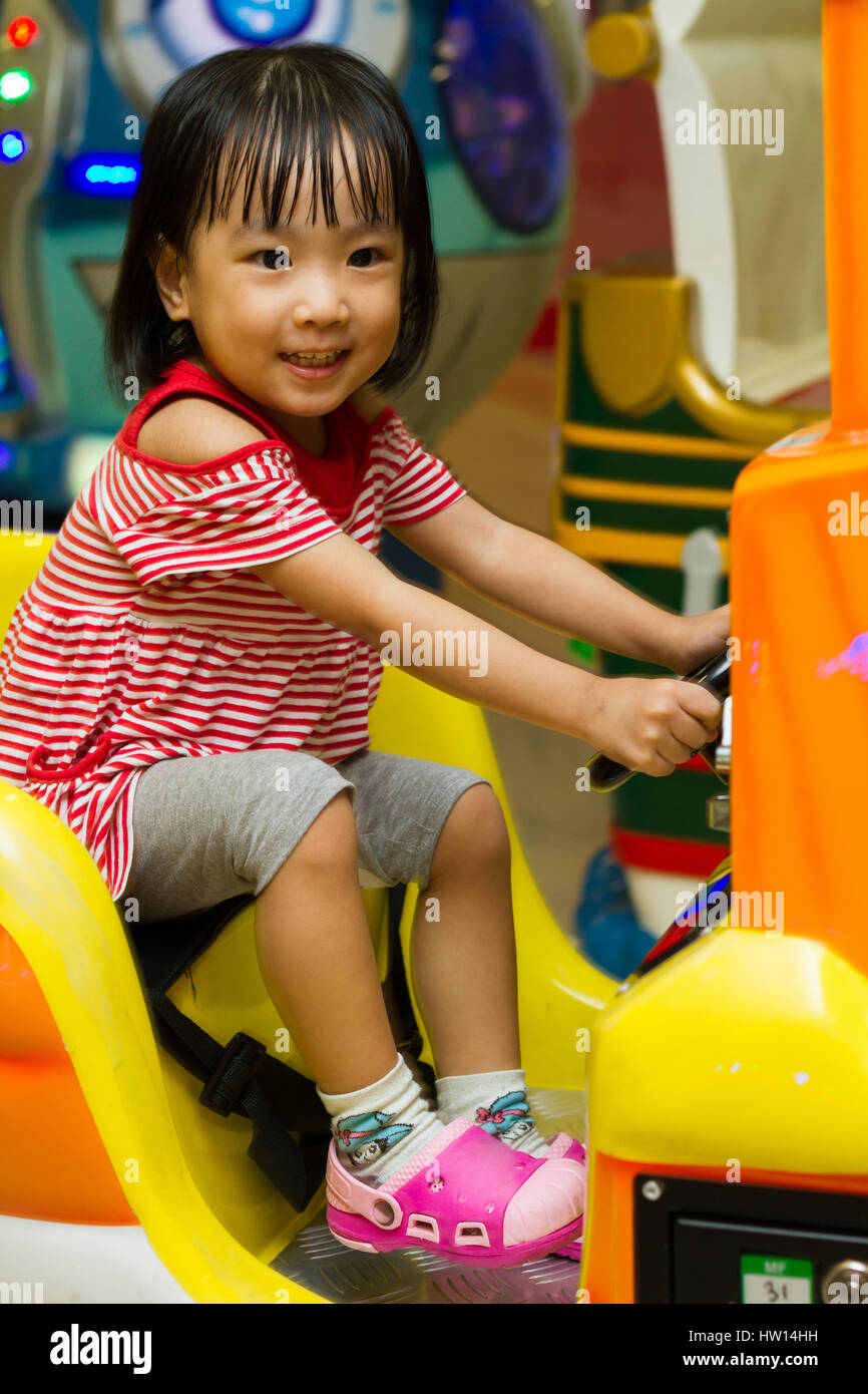 Happy Asian Chinese girl at indoor playground Stock Photo - Alamy