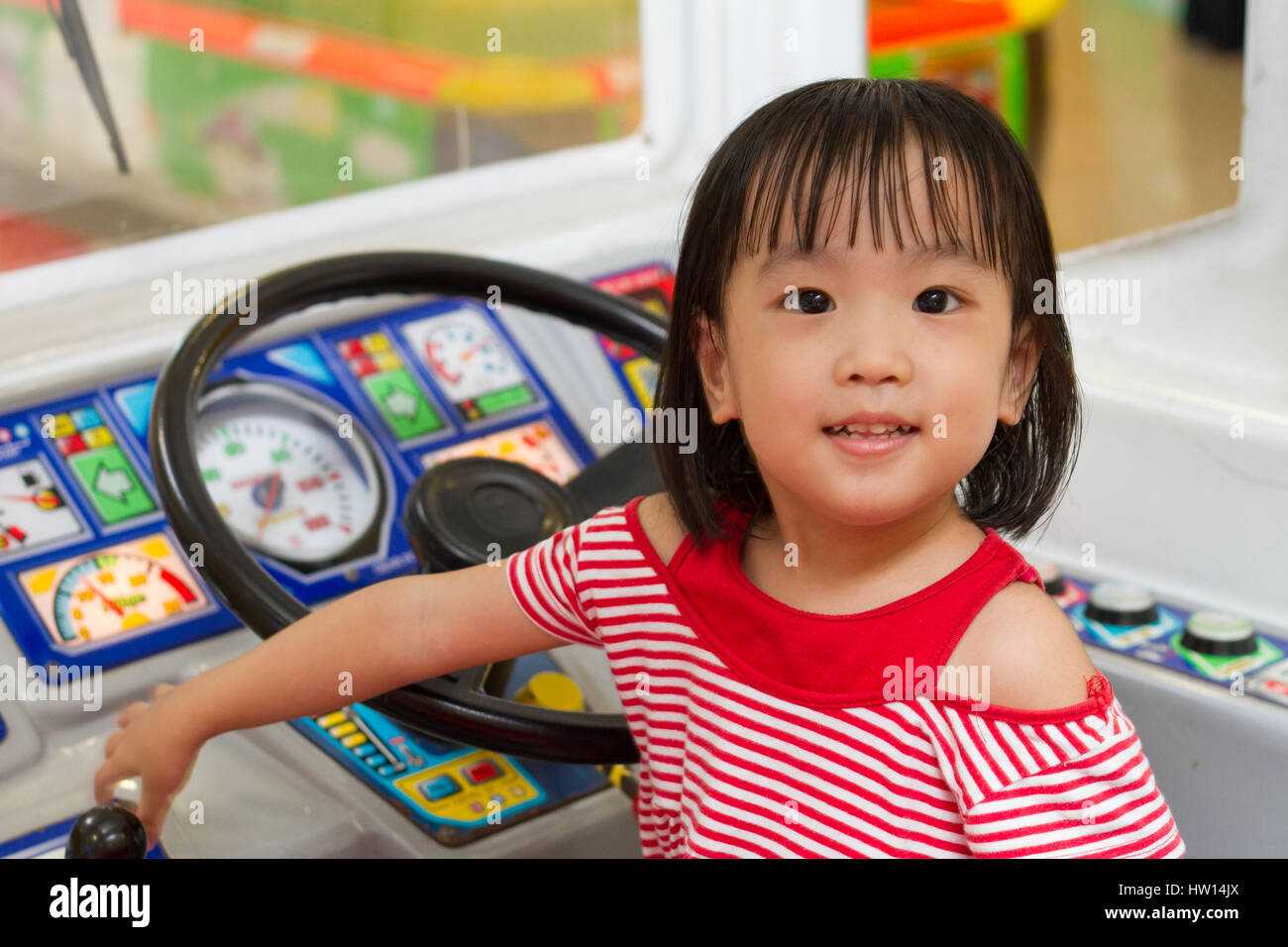 Little Asain Chinese Bus Driver at indoor playground Stock Photo - Alamy