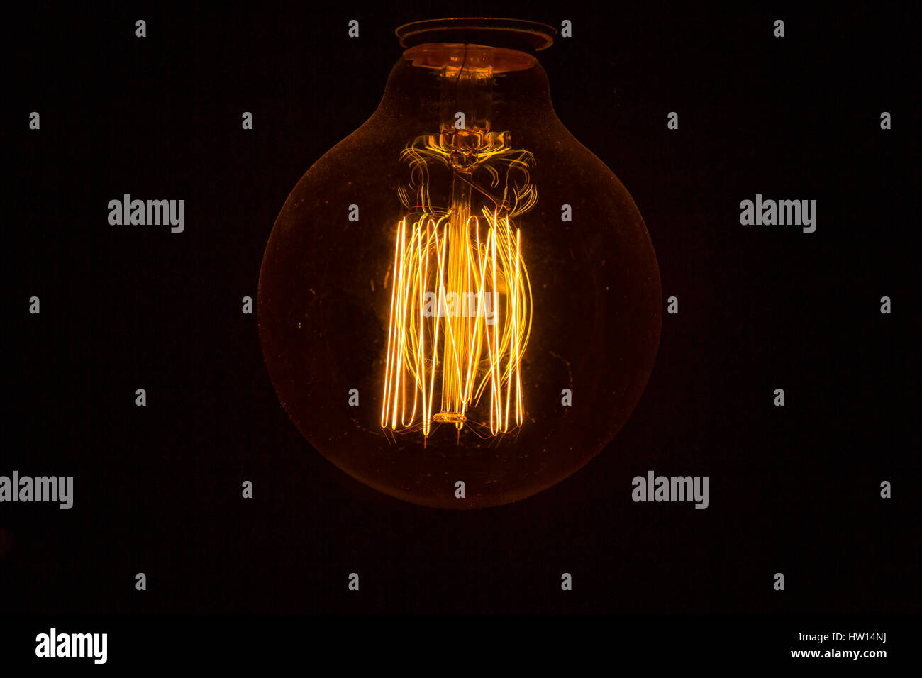 Incandescent lightbulb with a black background Stock Photo - Alamy