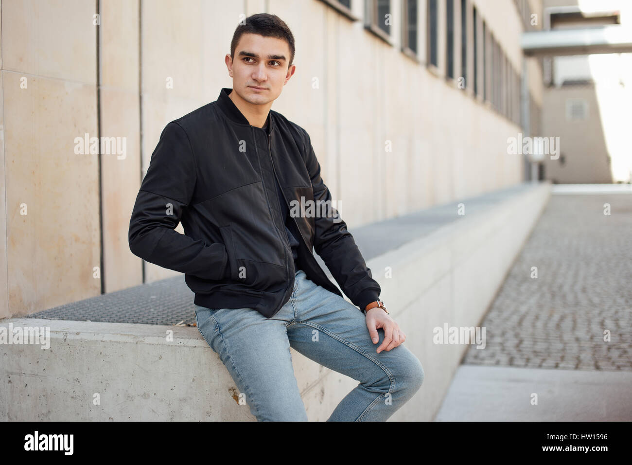 Fashionable man standing outdoors with white background Stock Photo - Alamy