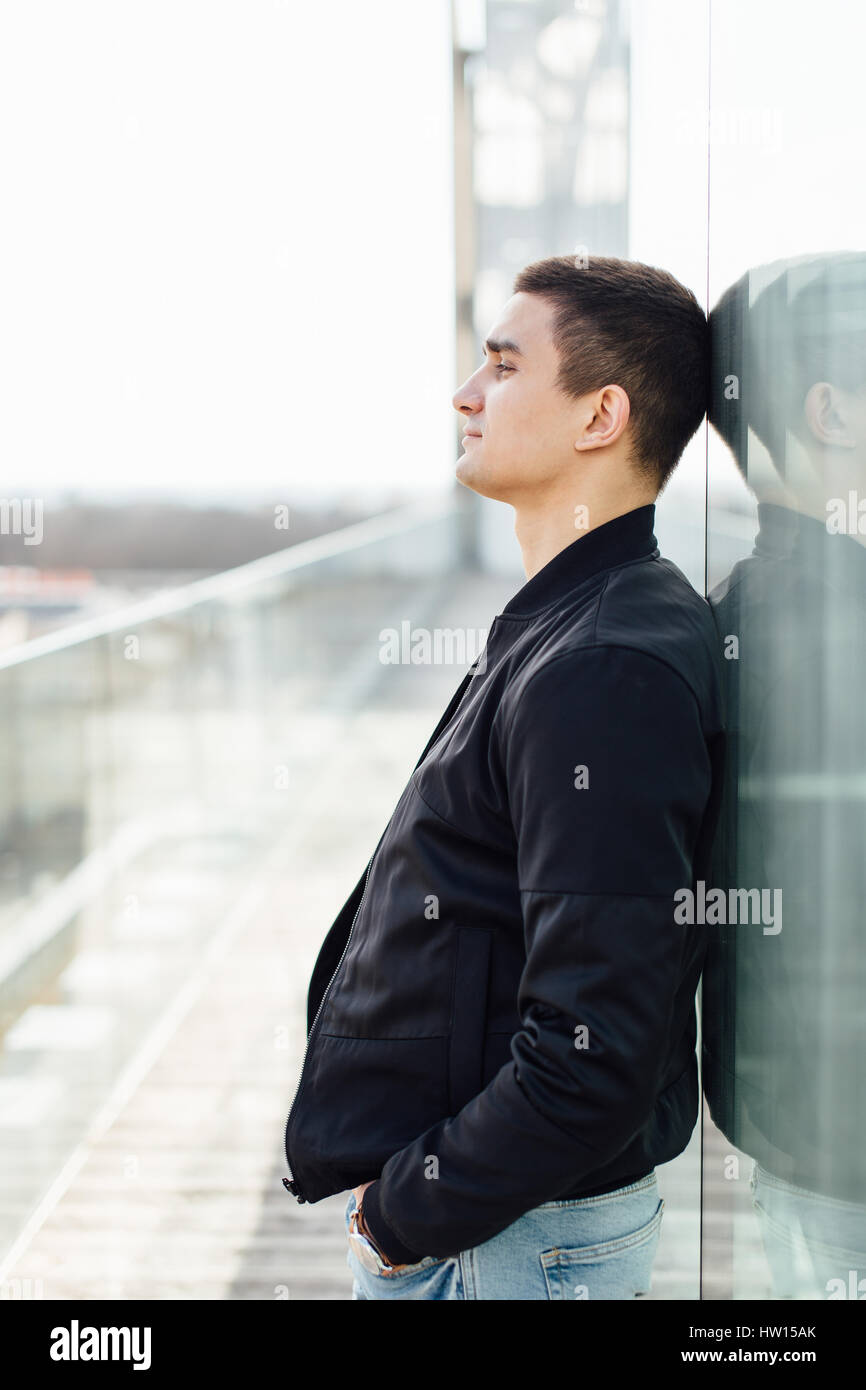 Fashionable man standing outdoors with white background Stock Photo - Alamy