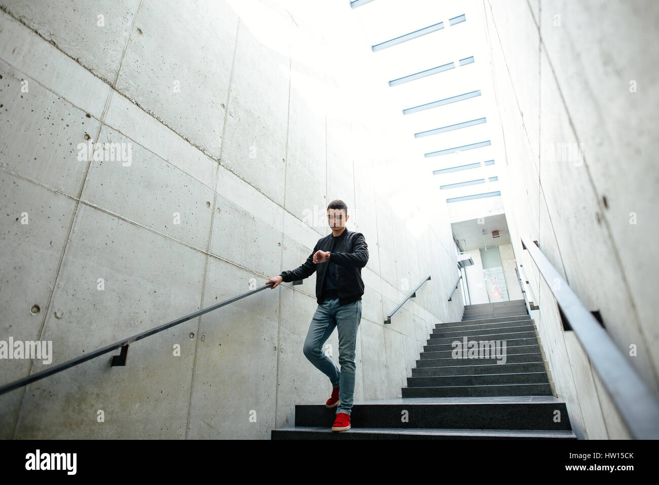 Fashionable man standing outdoors with white background Stock Photo - Alamy