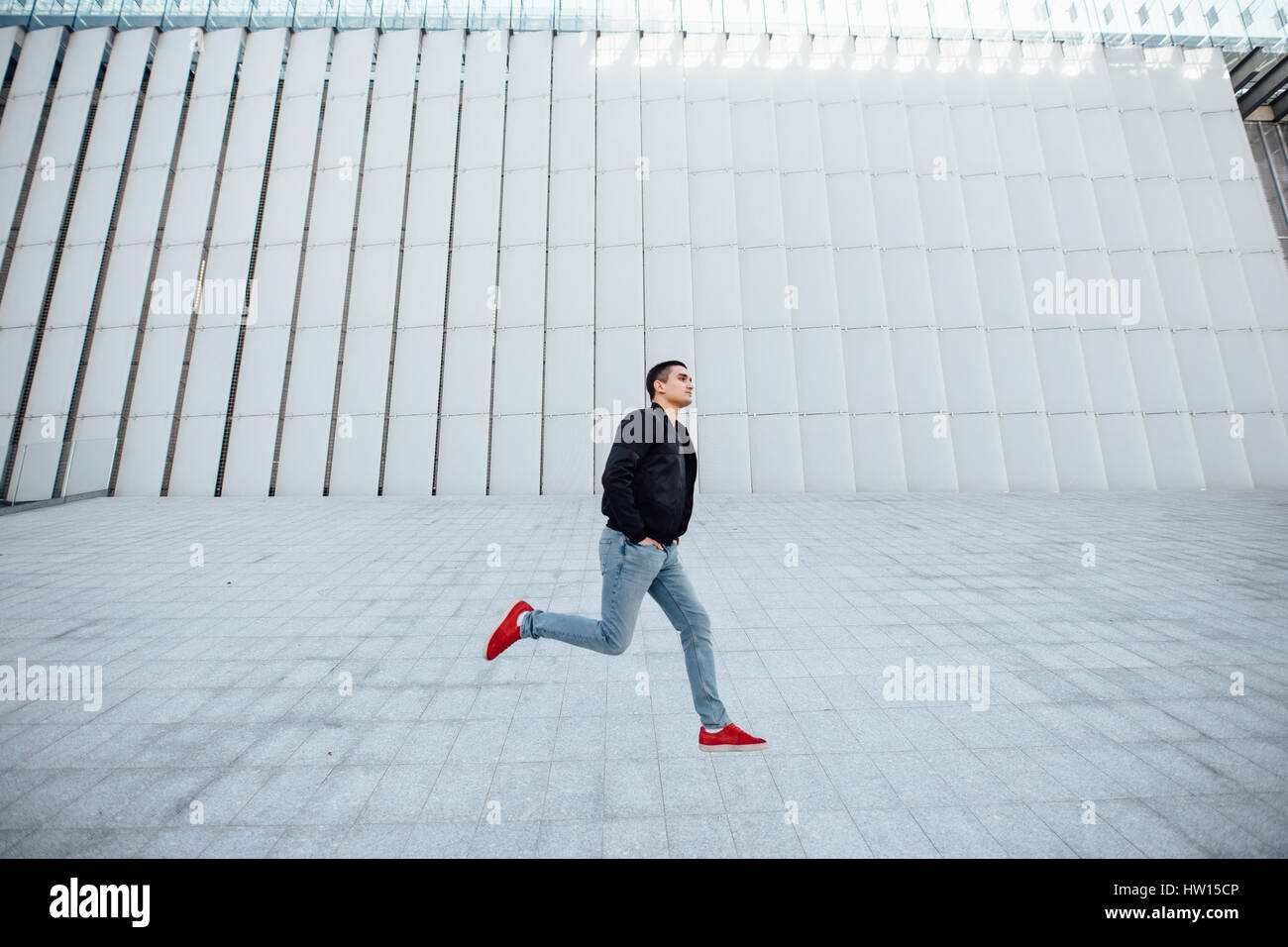 Funny guy jumping on the street with sunset Stock Photo - Alamy