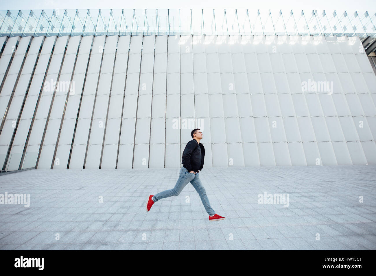 Funny guy jumping on the street with sunset Stock Photo - Alamy