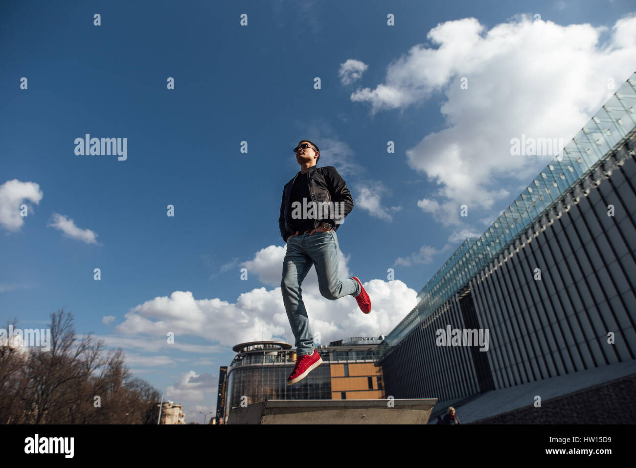 Funny guy jumping on the street with sunset Stock Photo - Alamy