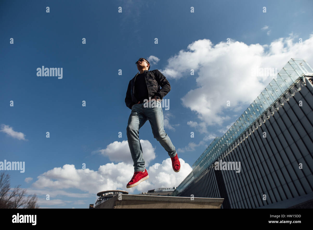 Funny guy jumping on the street with sunset Stock Photo - Alamy