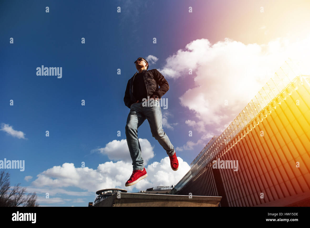 Funny guy jumping on the street with sunset Stock Photo - Alamy