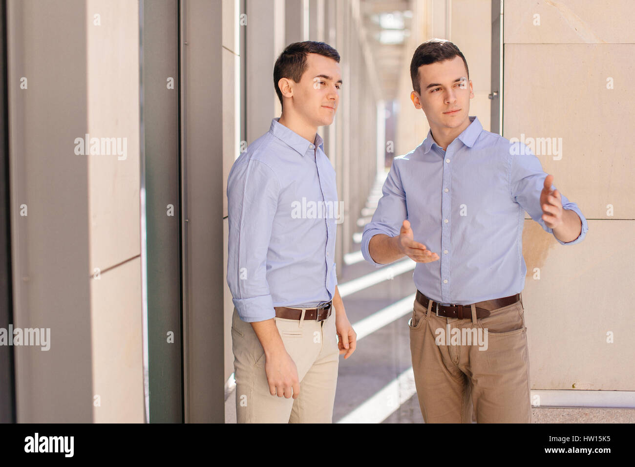 Two businessman talking about business with street city blur background ...