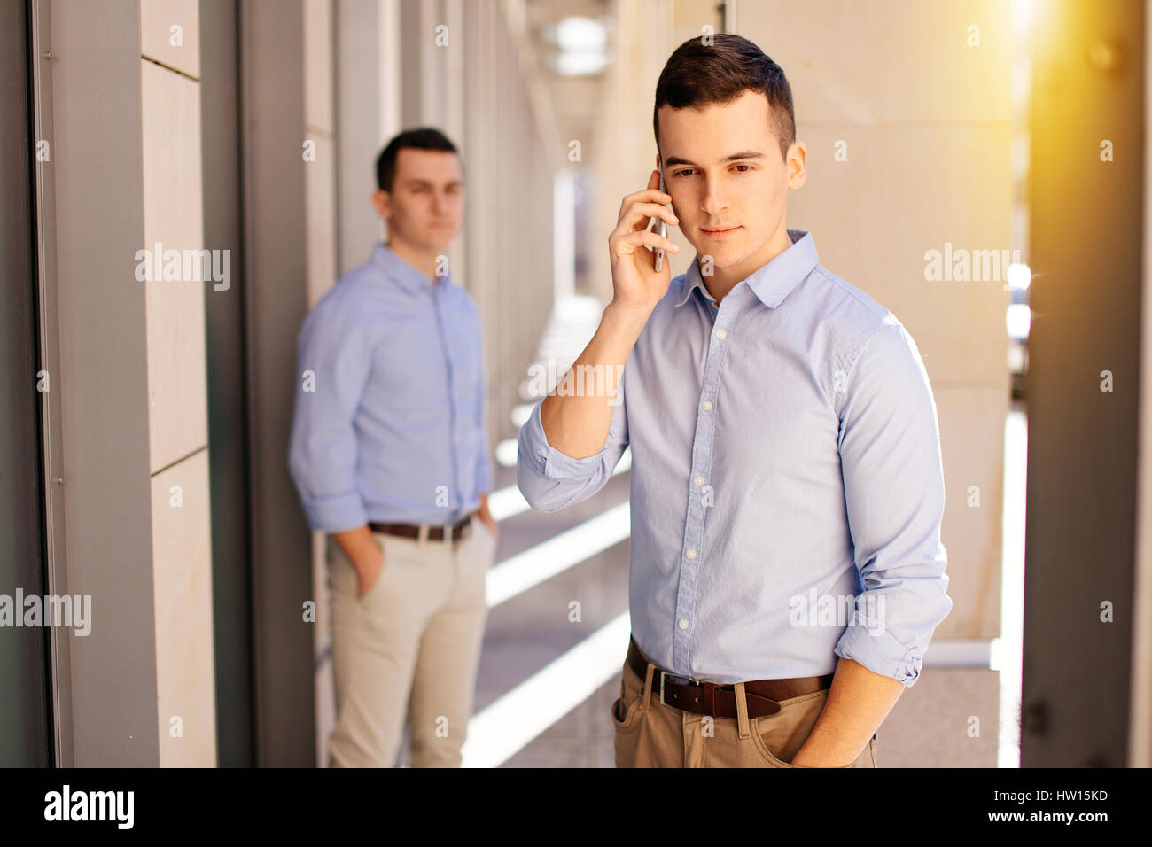 Businessman talking at his phone with friend on blur background Stock ...