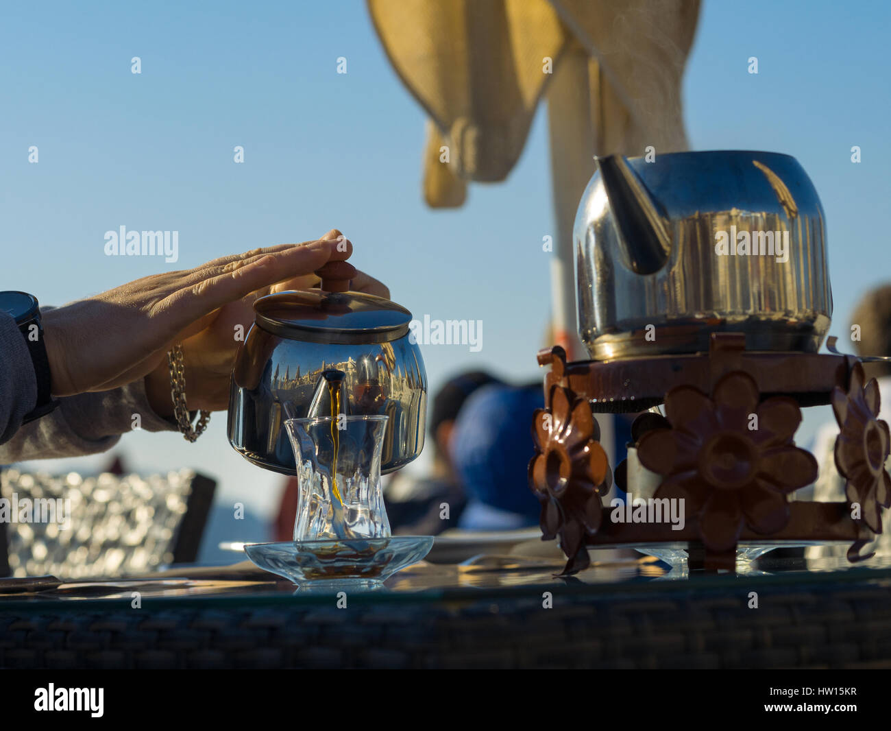 Pouring tea to a turkish tea glass from double turkish tea pot Stock ...