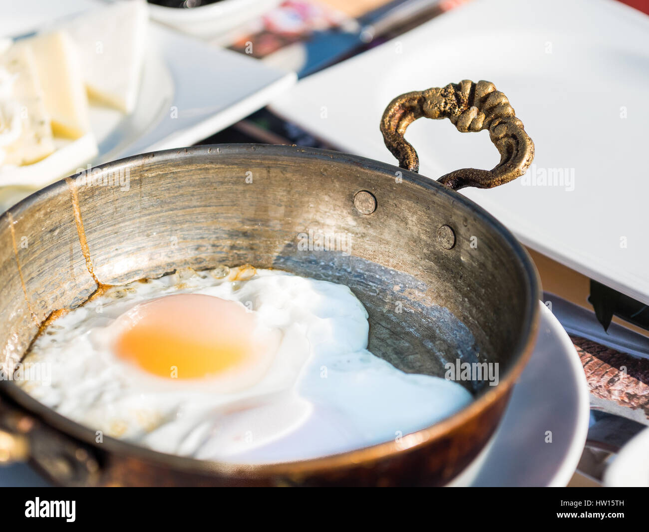 Fry sunny eggs in a silver serving pan Stock Photo - Alamy