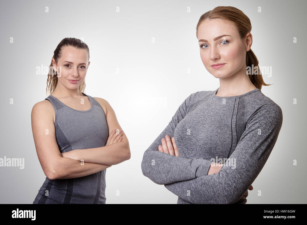 Portrait Of Smiling Young Fitness Women With Folded Arms Stock Photo ...