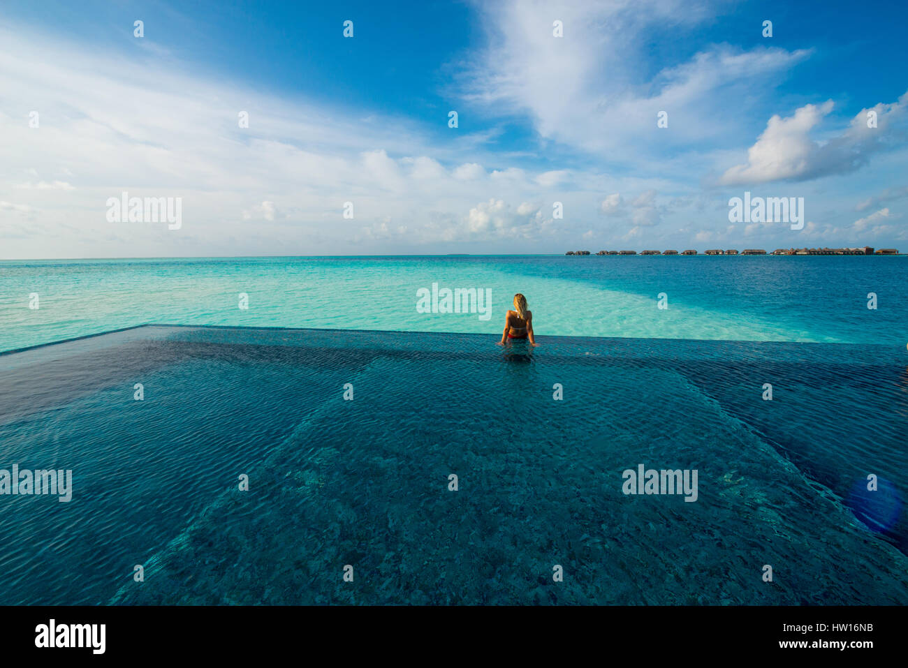 Maldives, Rangali Island. Conrad Hilton Resort. Woman in an infinity ...
