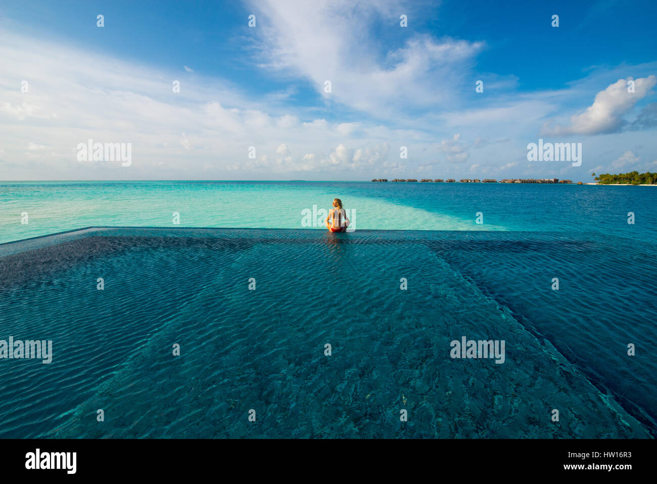 Maldives, Rangali Island. Conrad Hilton Resort. Woman in an infinity ...