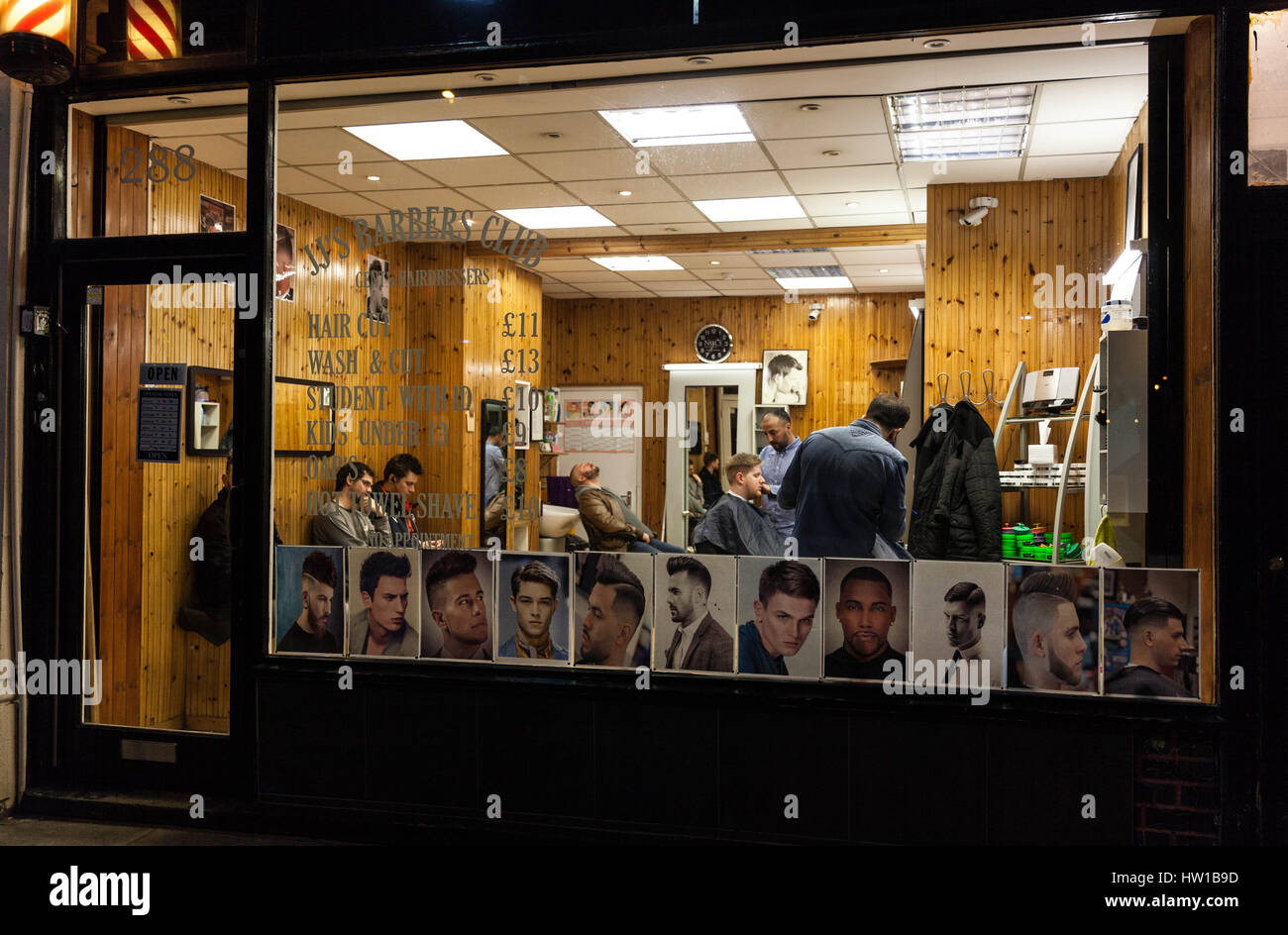 Barber shop seen through a glass window, Holloway Road, London, England ...
