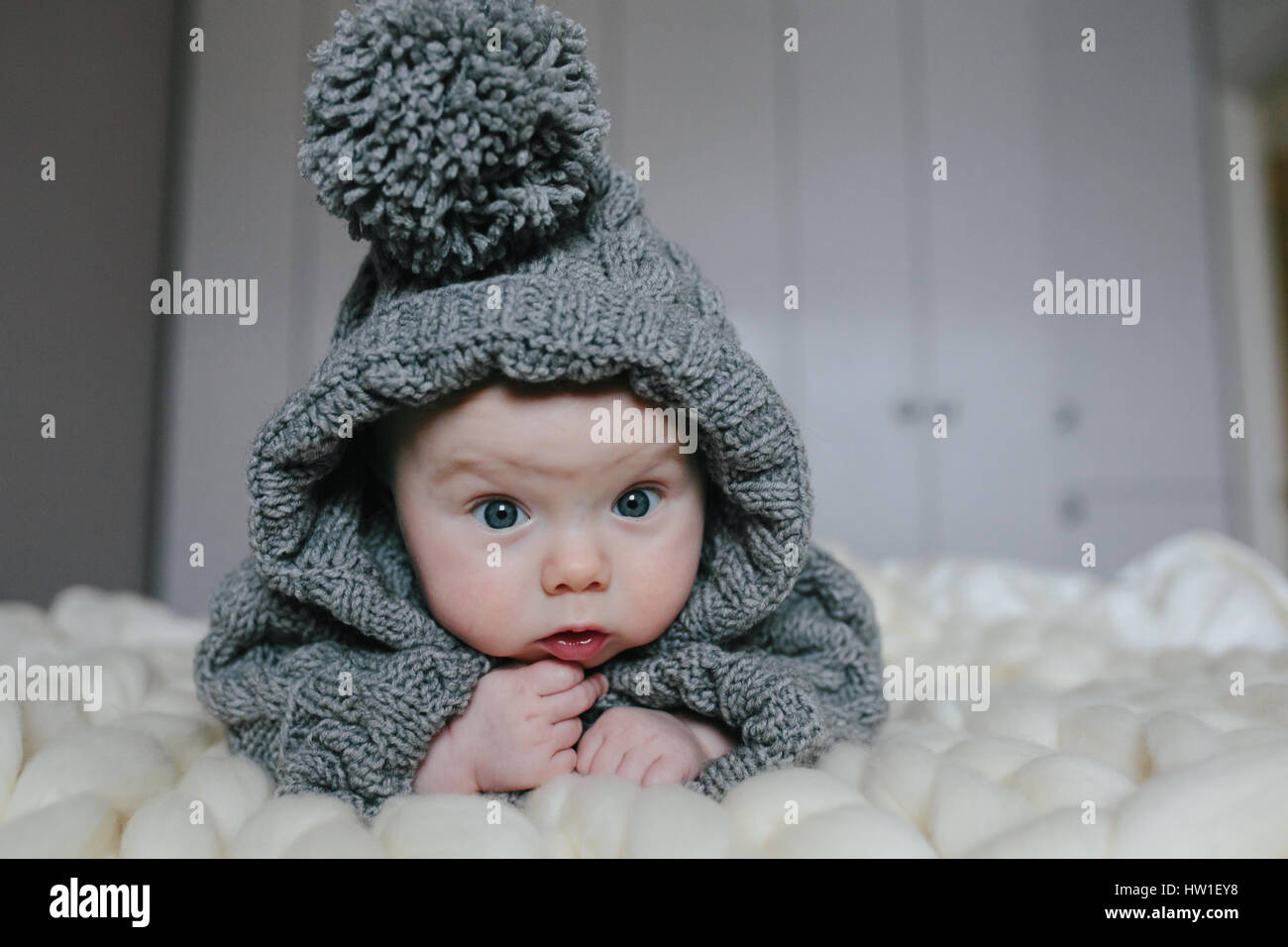 Small baby in knitted clothes Stock Photo - Alamy