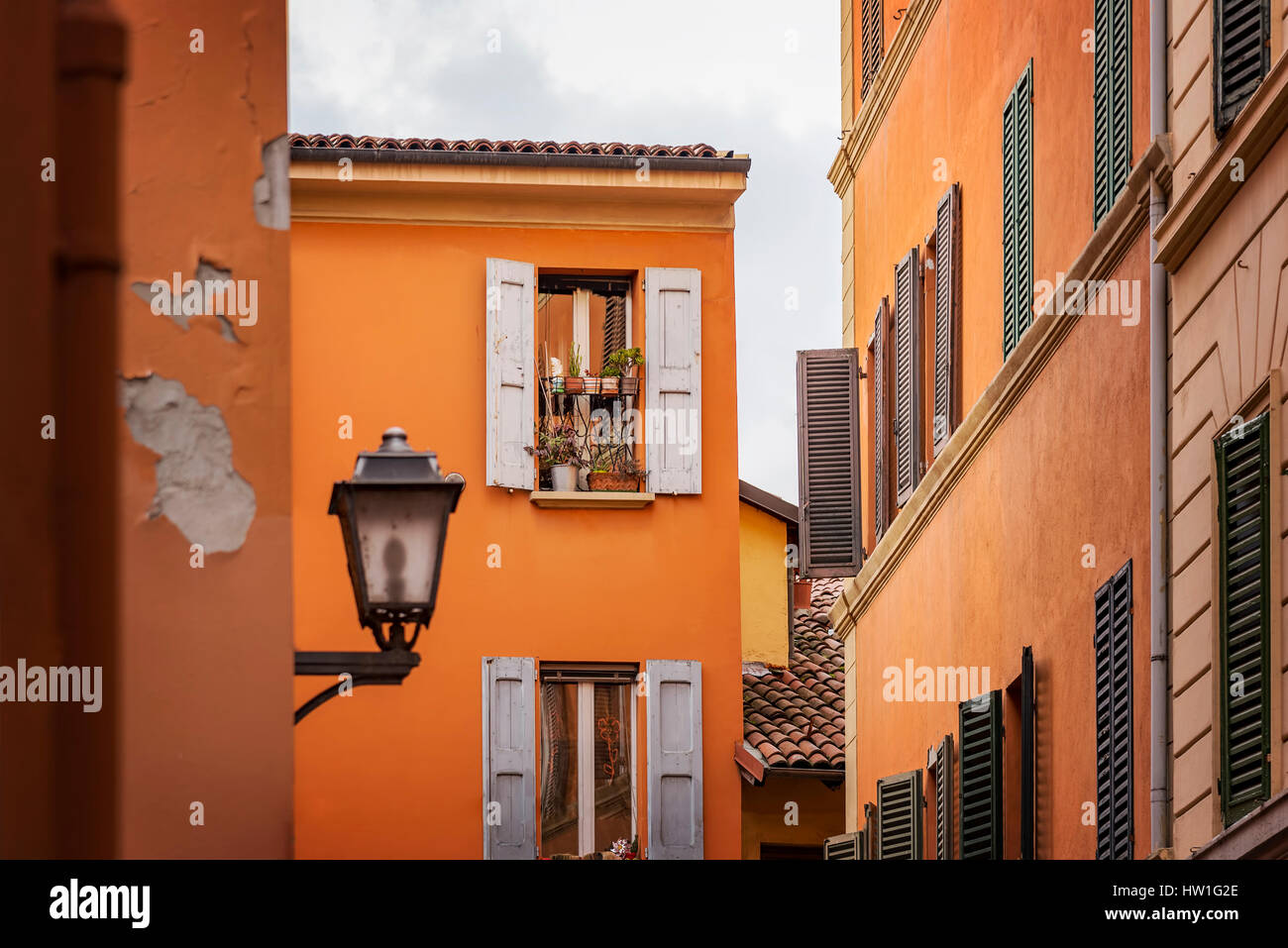 Image of street corner with brightly painted buildings in Bologna ...