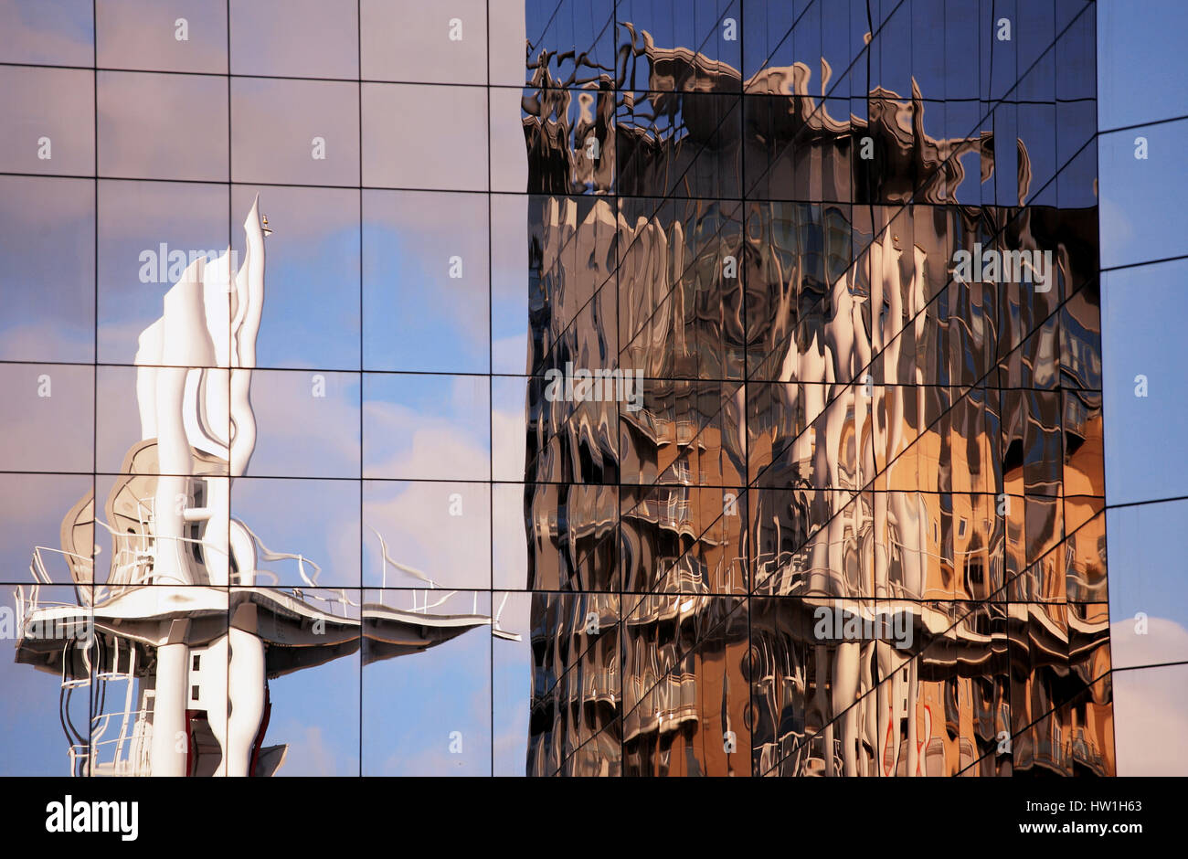 Quay West, Media City: glass building reflecting the Milennium Bridge ...