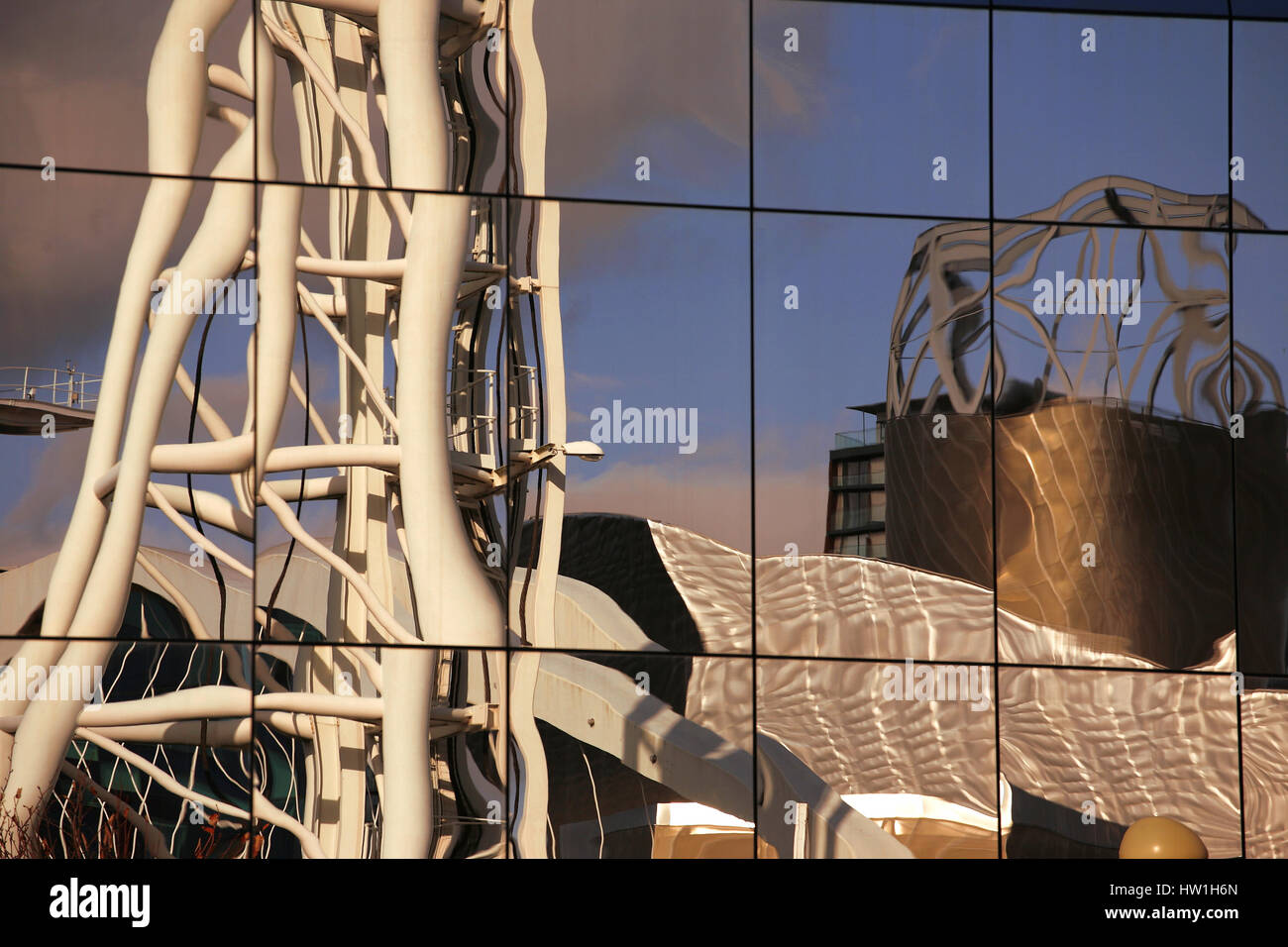 Quay West, Media City: glass building reflecting the Milennium Bridge ...