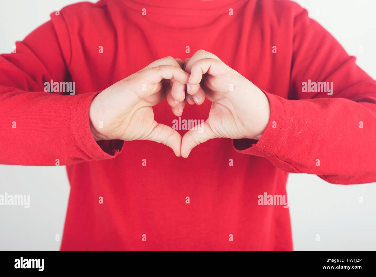 child hands showing sign of heart child hands showing sign of heart ...