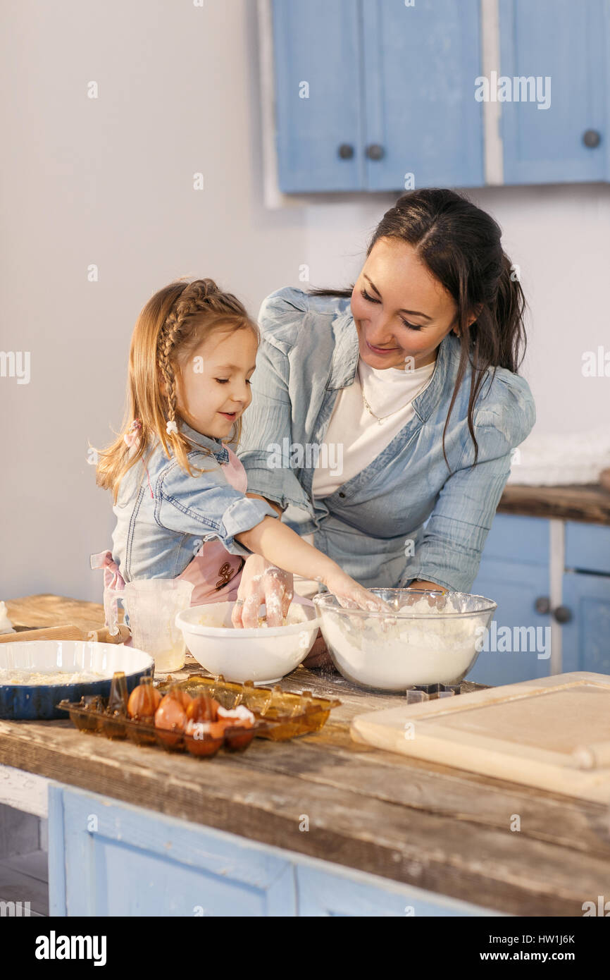 Woman showing how to cook to her little daughter Stock Photo - Alamy