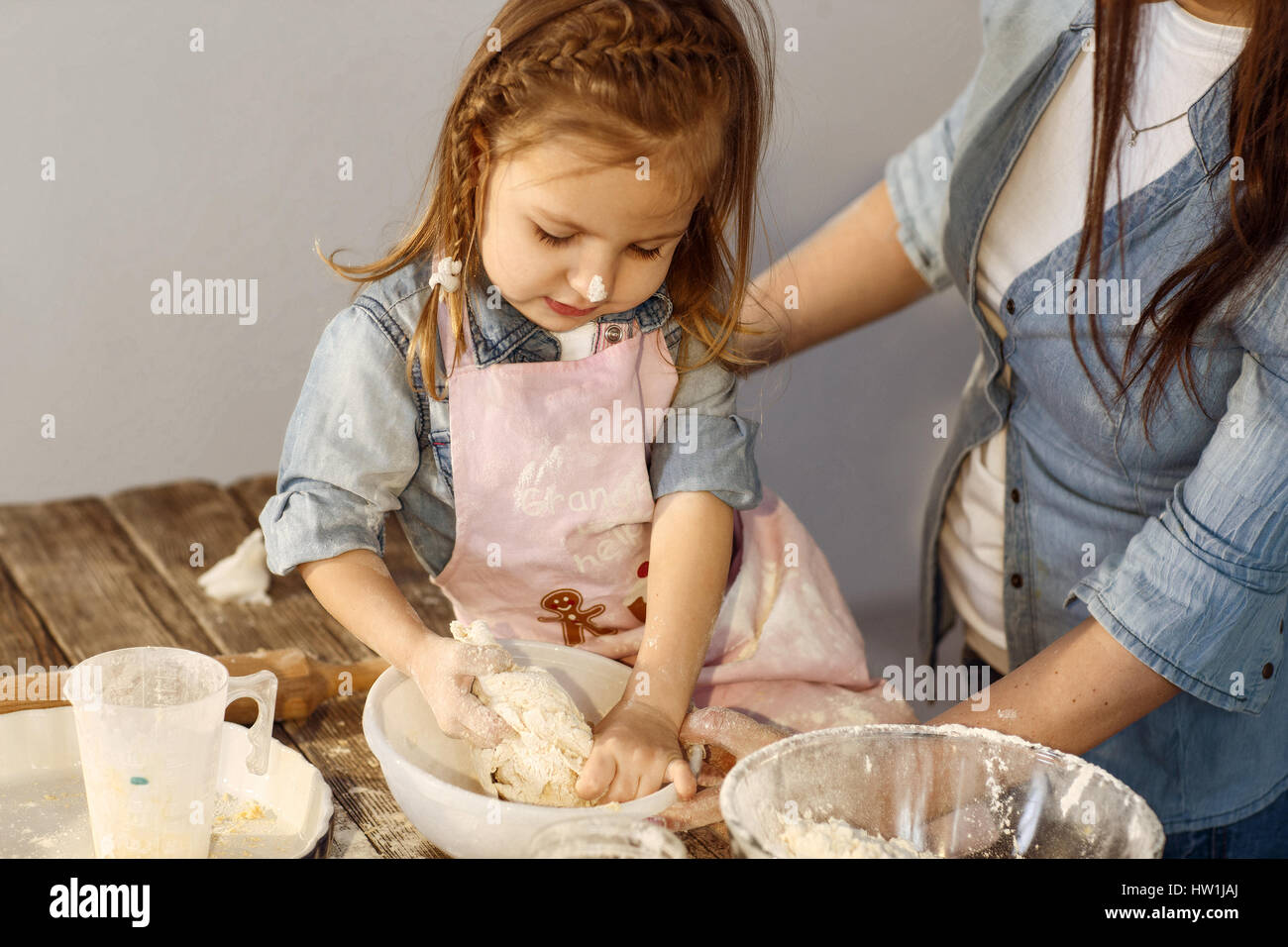Kid cooking while seating on a table Stock Photo - Alamy