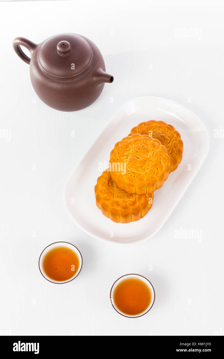 Chinese mid autumn festival with moon cake and tea pot setup in plain ...