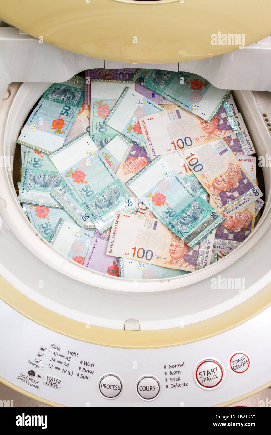 Money laundering concept with Ringgit Malaysia notes in washing machine ...
