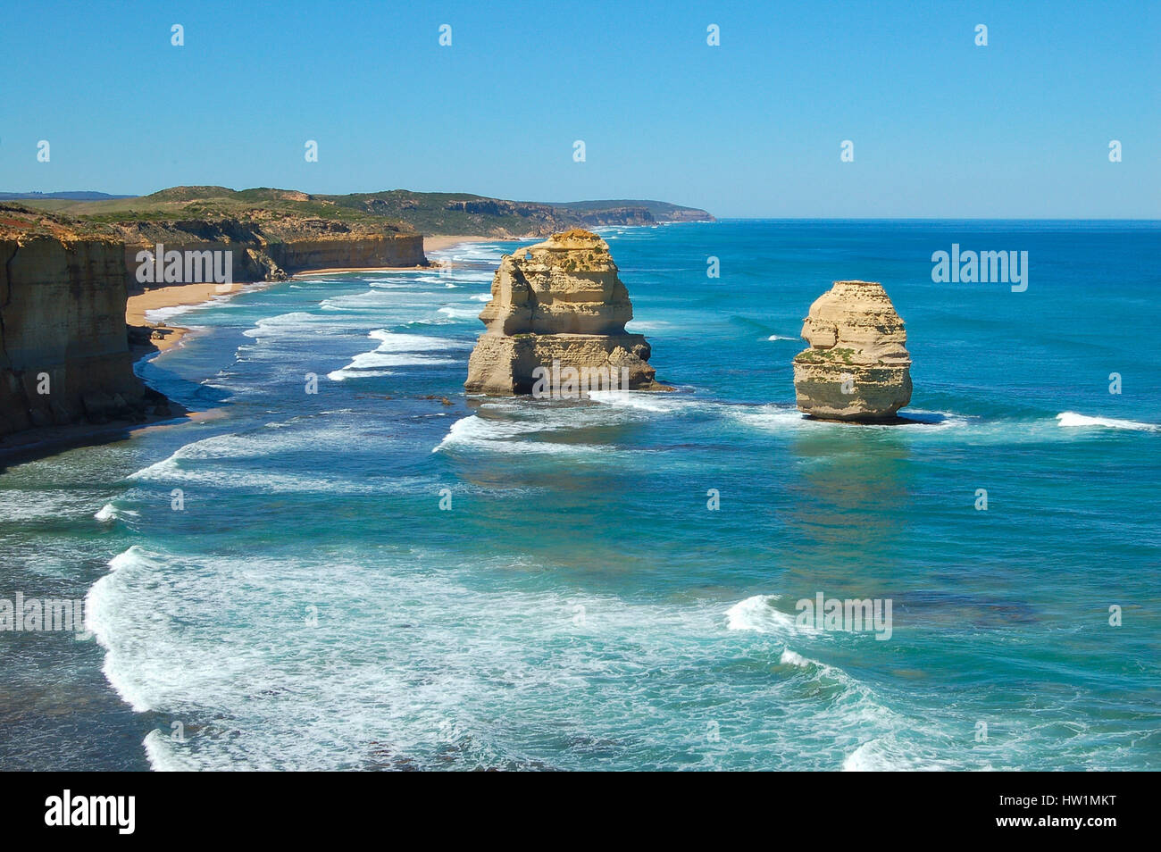 Two eroding limestone stacks standing in the blue water at the Twelve ...