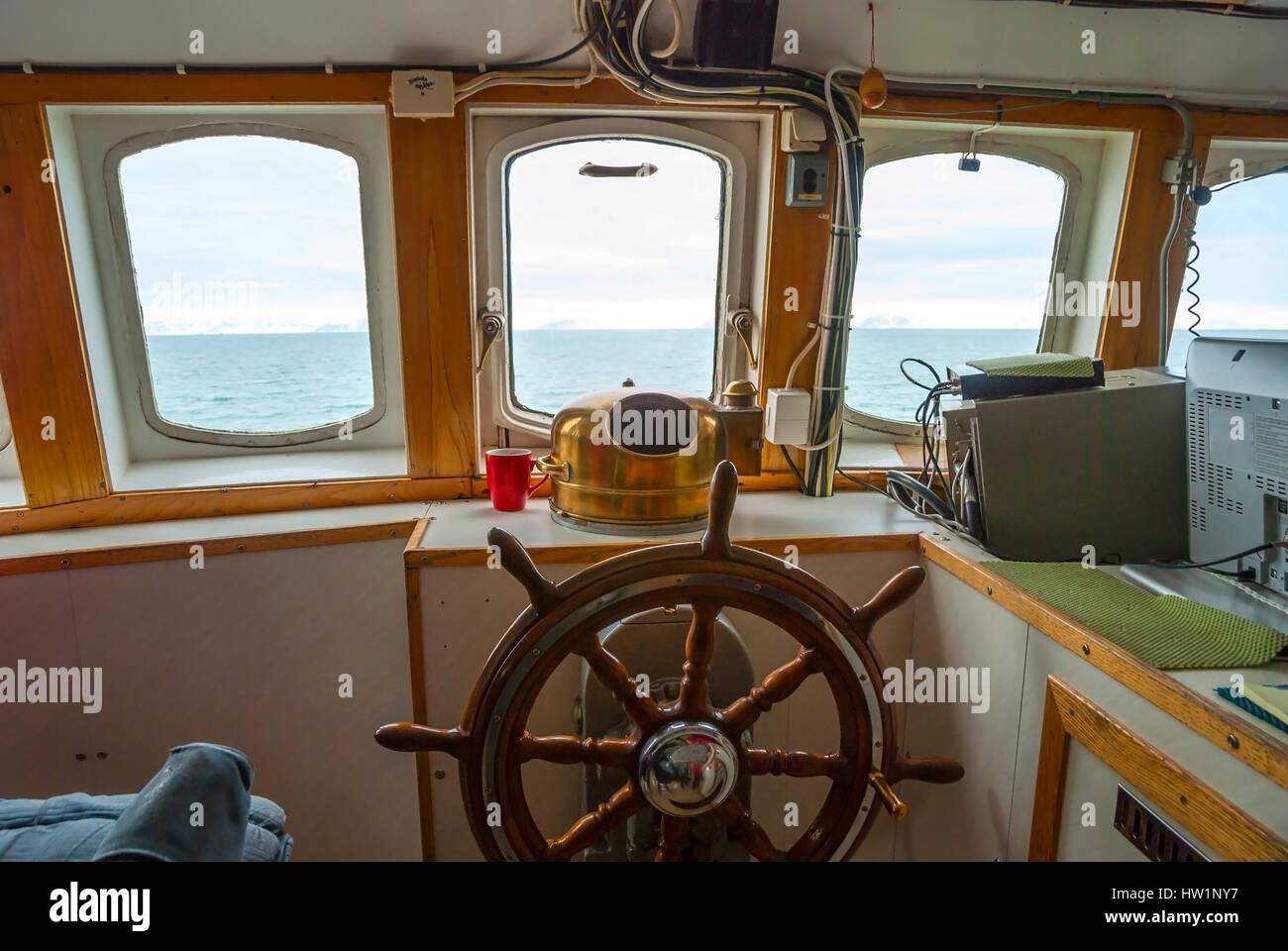 View trough capitan cabin window with steering wheen on the boat Stock ...