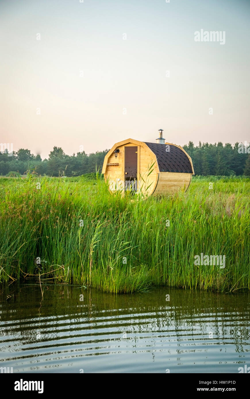 Wooden outdoor sauna by the lake in summer sunset Stock Photo - Alamy