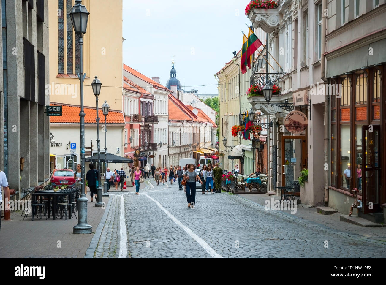 VILNIUS, LITHUANIA - JULY 8: Woman on bicycle riding on the street of ...