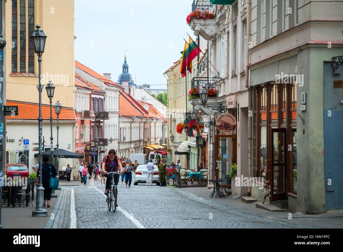 VILNIUS, LITHUANIA - JULY 8: Woman on bicycle riding on the street of ...