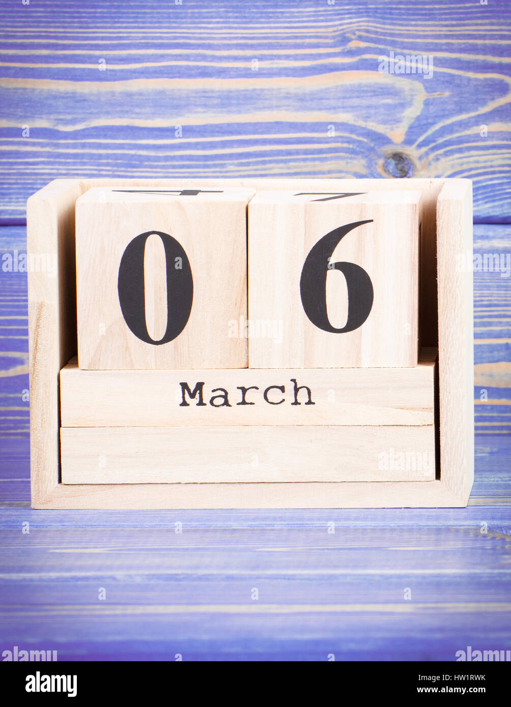 March 6th. Date of 6 March on wooden cube calendar, purple board as ...