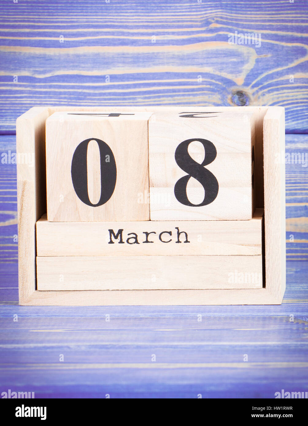 March 8th. Date of 8 March on wooden cube calendar, purple board as ...