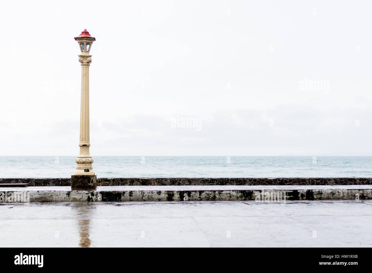 A victorian retro lamp post and road side curb and path at the sea side ...