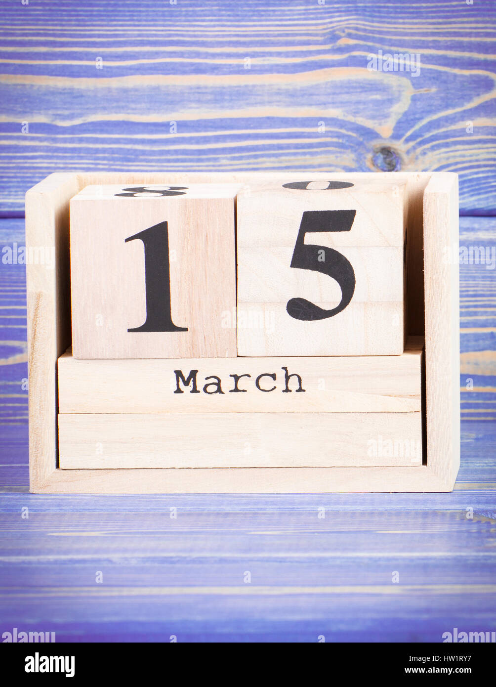 March 15th. Date of 15 March on wooden cube calendar, purple board as ...
