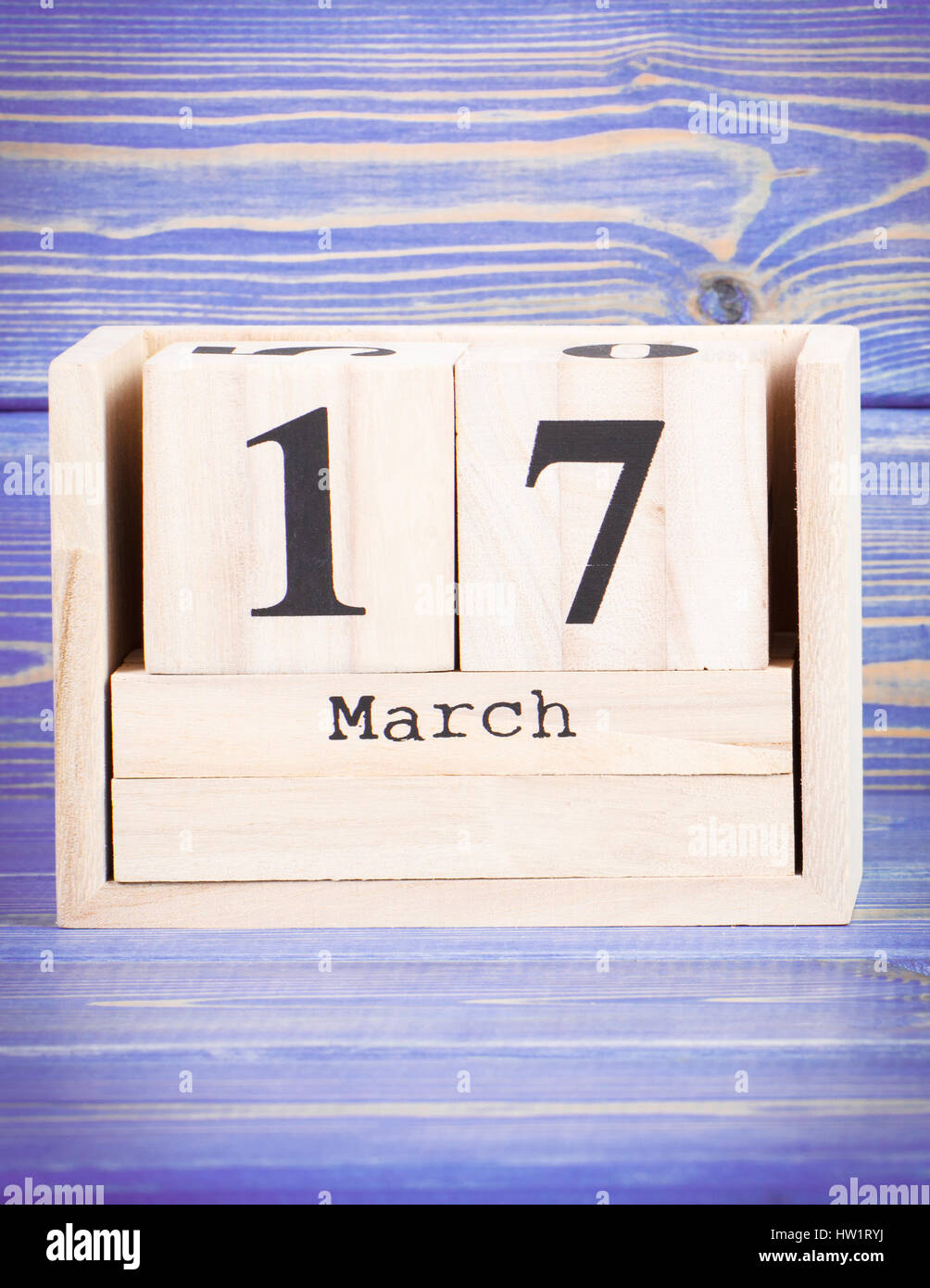 March 17th. Date of 17 March on wooden cube calendar, purple board as ...