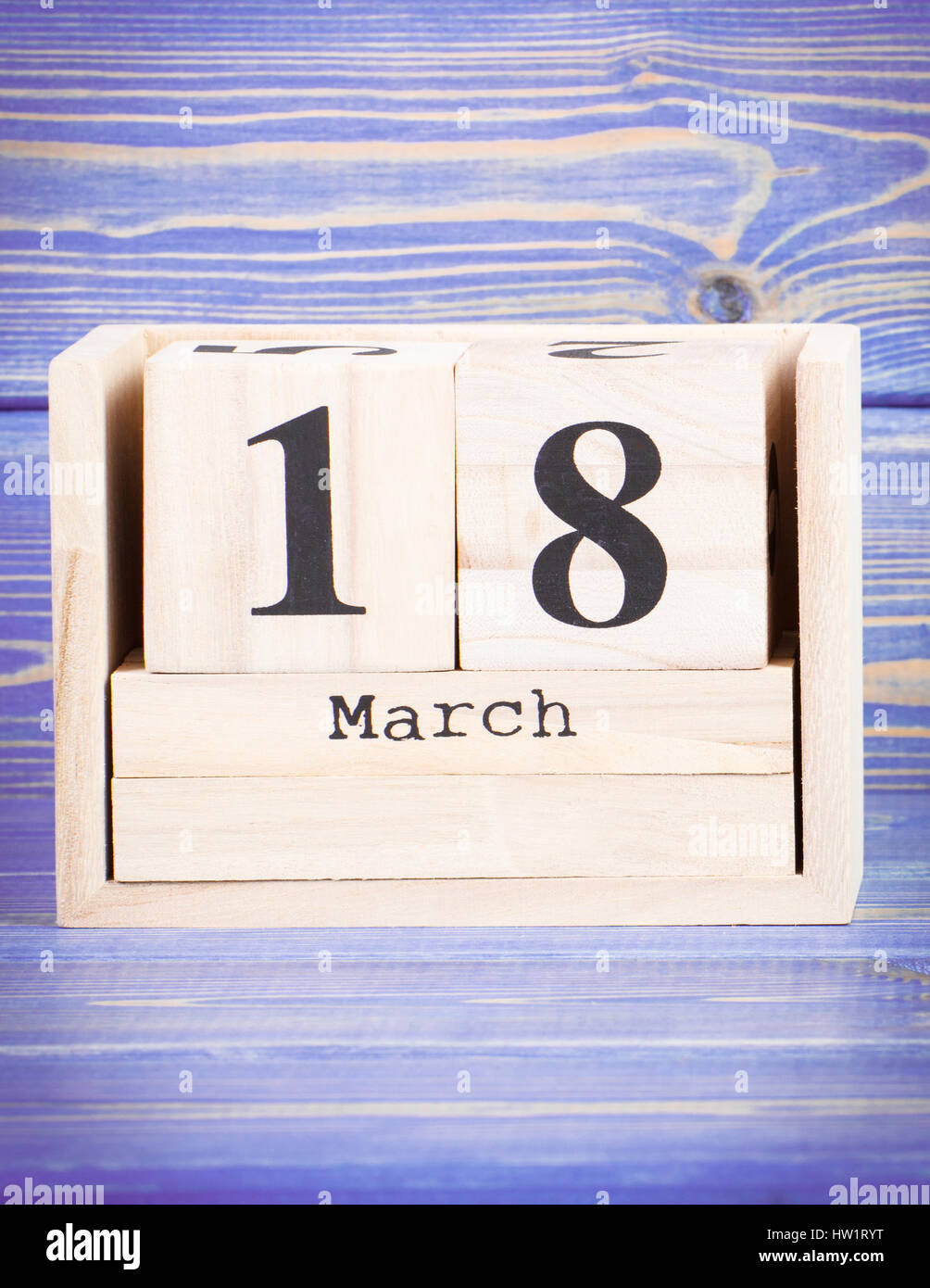 March 18th. Date of 18 March on wooden cube calendar, purple board as ...