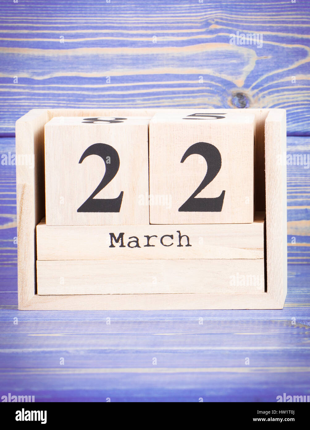 March 22th. Date of 22 March on wooden cube calendar, purple board as ...