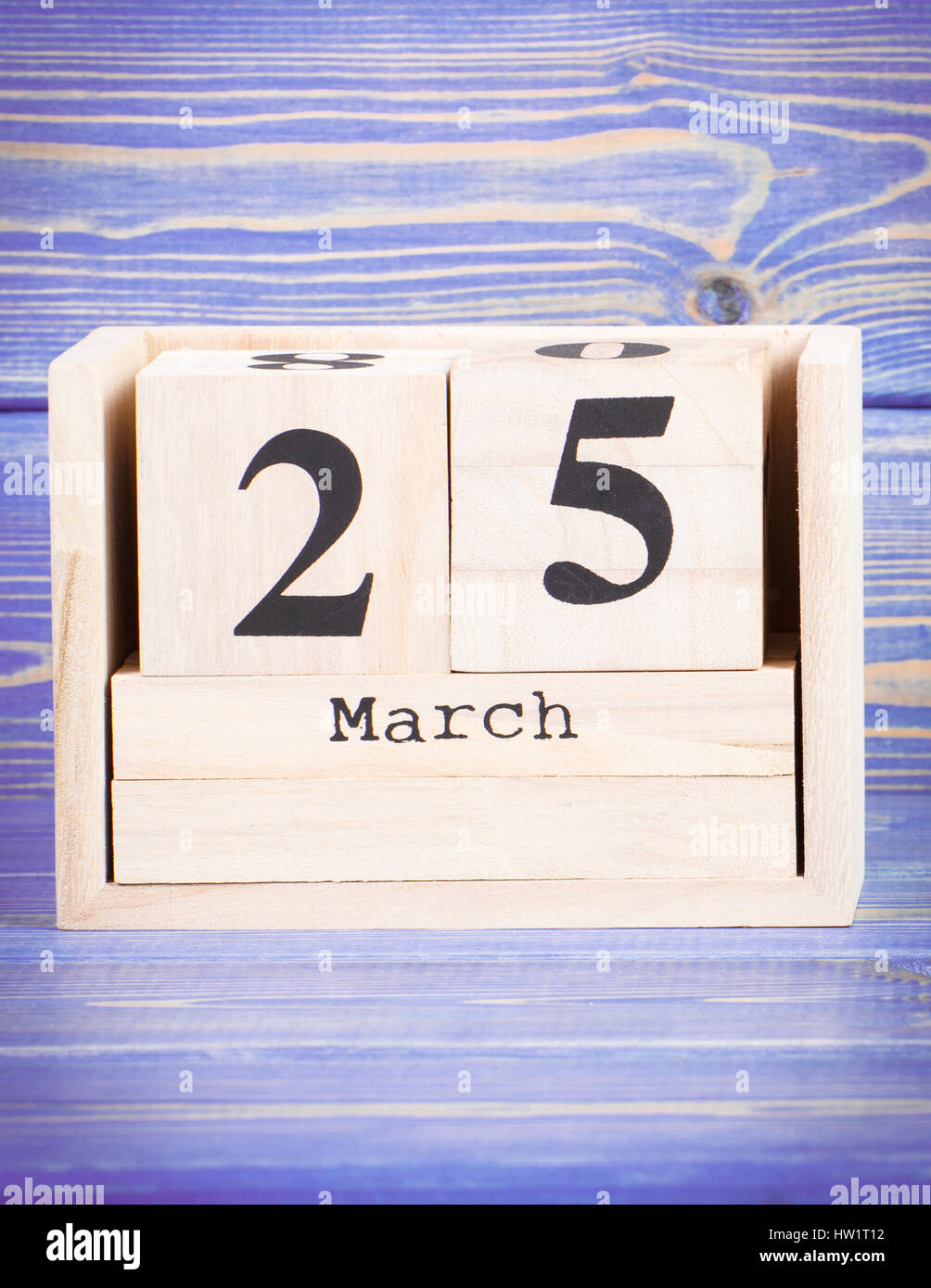 March 25th. Date of 25 March on wooden cube calendar, purple board as ...