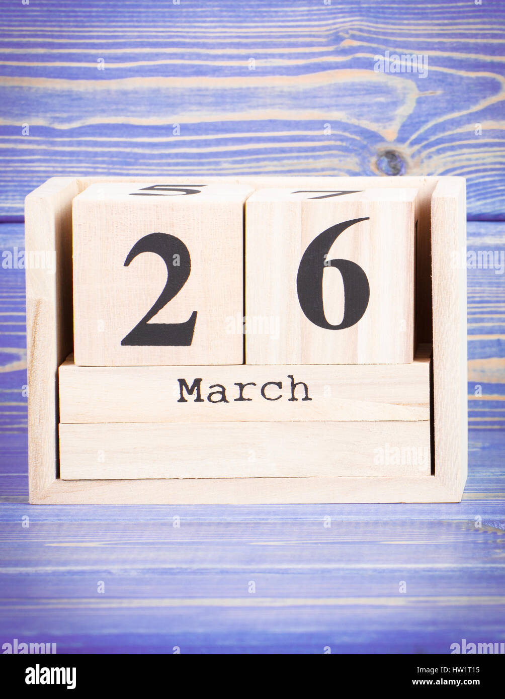 March 26th. Date of 26 March on wooden cube calendar, purple board as ...