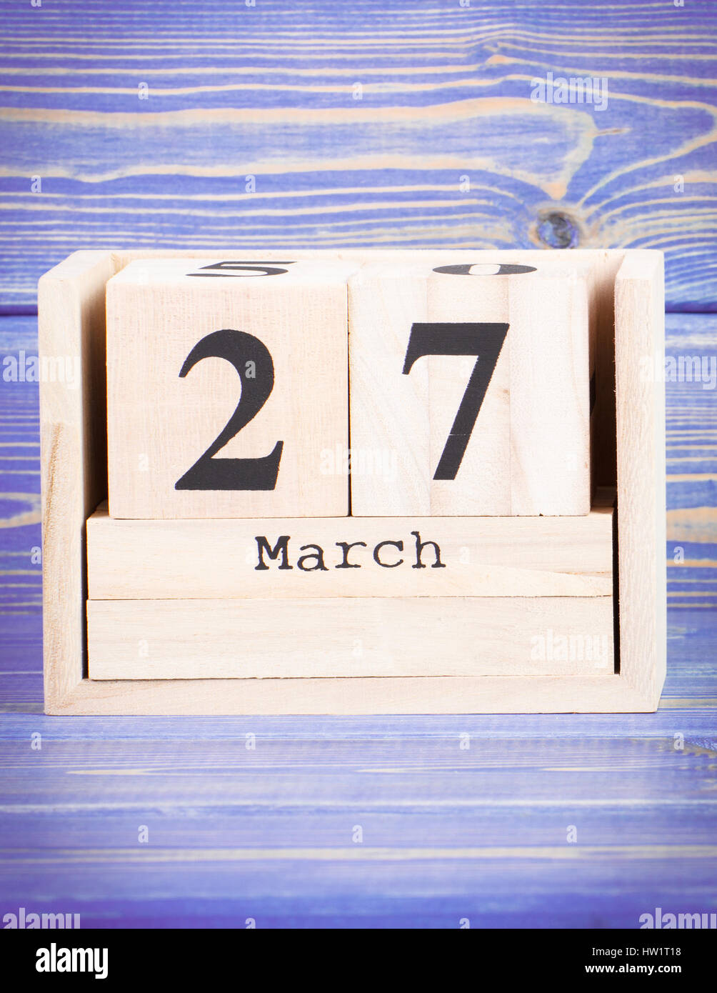 March 27th. Date of 27 March on wooden cube calendar, purple board as ...