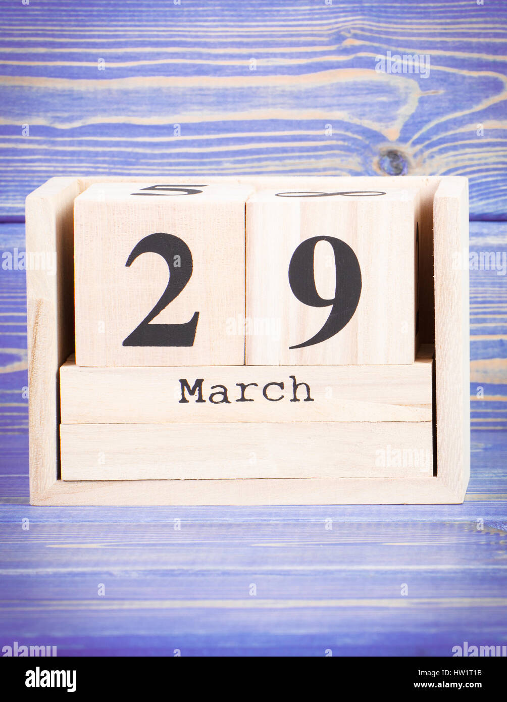 March 29th. Date of 29 March on wooden cube calendar, purple board as ...