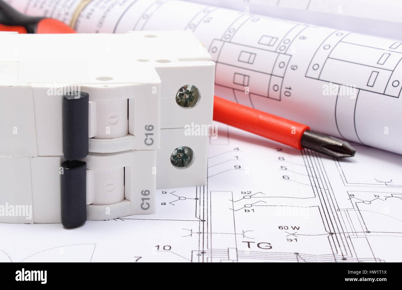 Rolls of electrical diagrams, electric fuse and work tools lying on ...