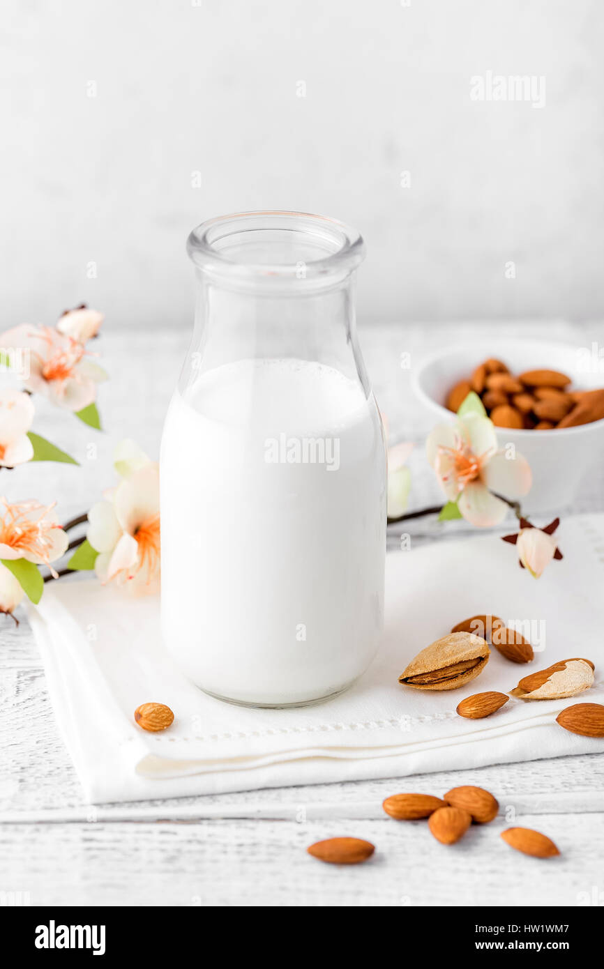 Almond nuts and milk on white background Stock Photo - Alamy