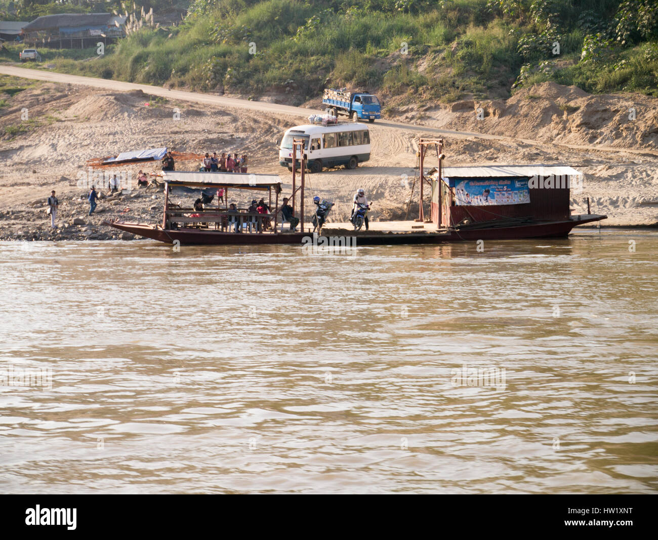 A very rickety looking ferry on the Mekong River used for people ...
