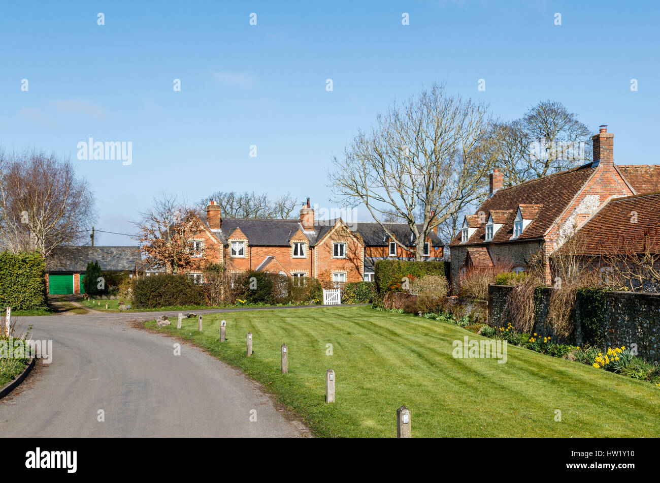 Typical attractive red-brick cottages around the village green at Aston ...