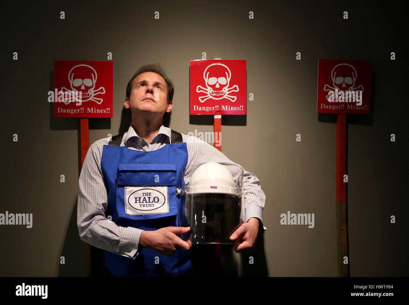 James Cowan, CEO of The Halo Trust, holds a protective helmet with face ...