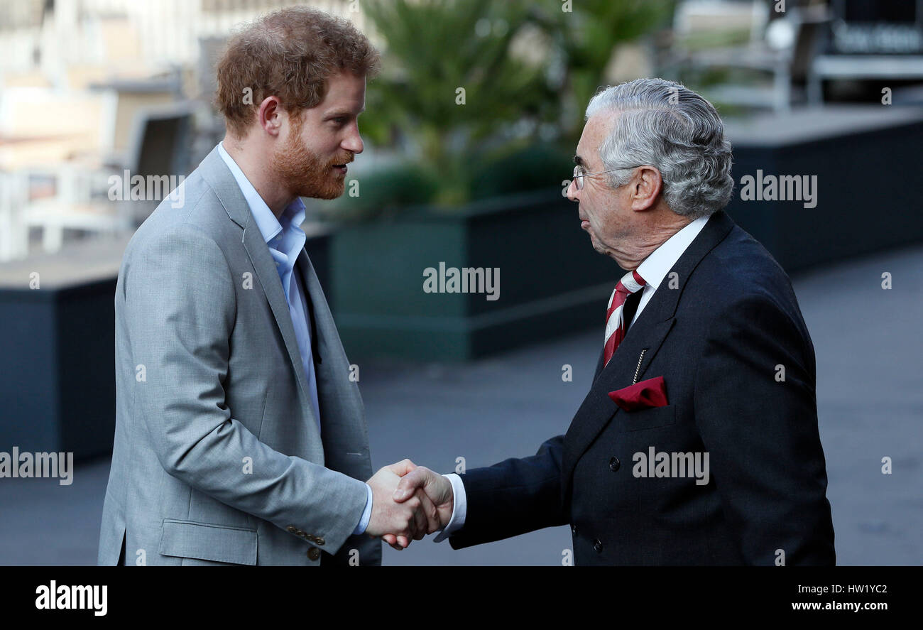 Prince Harry (left) is greeted by Dr Paul Knapman as he arrives for the ...